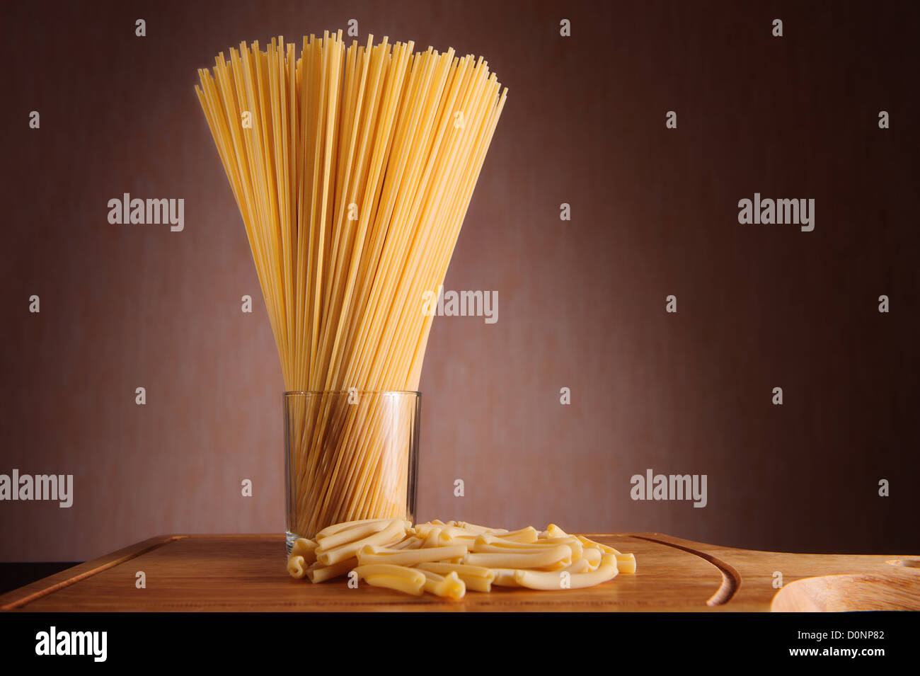 A bunch of long spaghetti pasta over dark background Stock Photo - Alamy