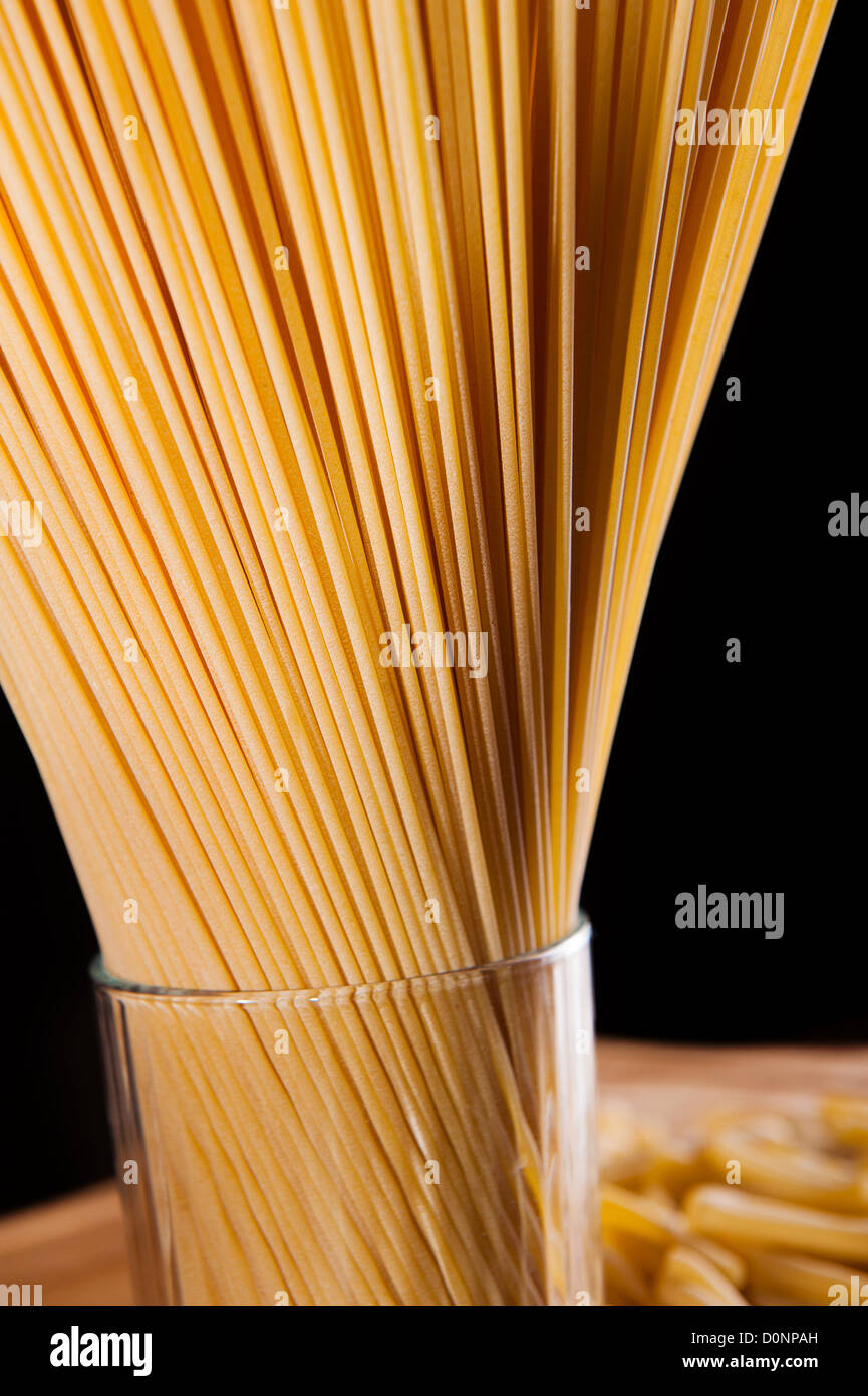 A bunch of long spaghetti pasta over dark background Stock Photo - Alamy
