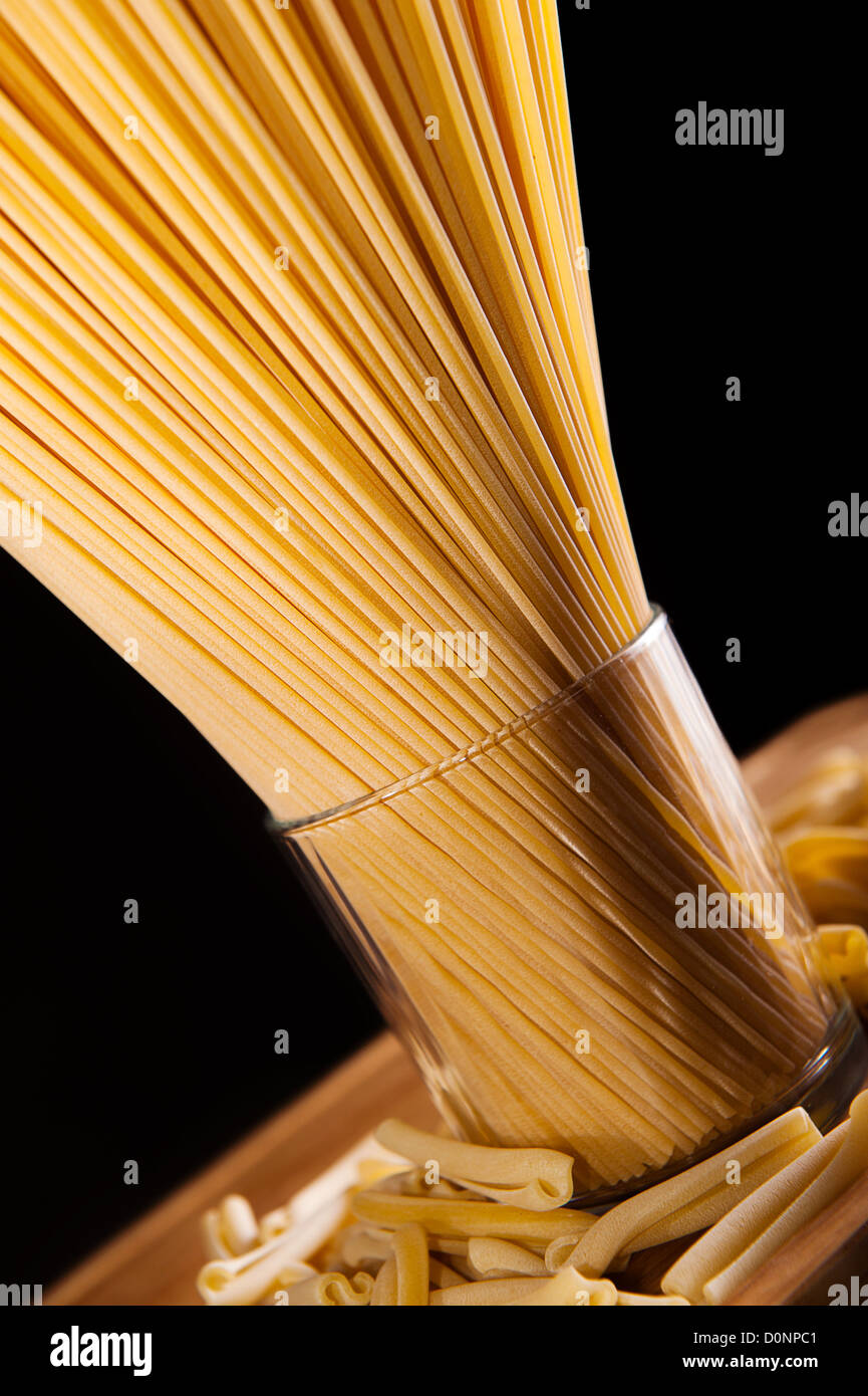 A bunch of long spaghetti pasta over dark background Stock Photo - Alamy