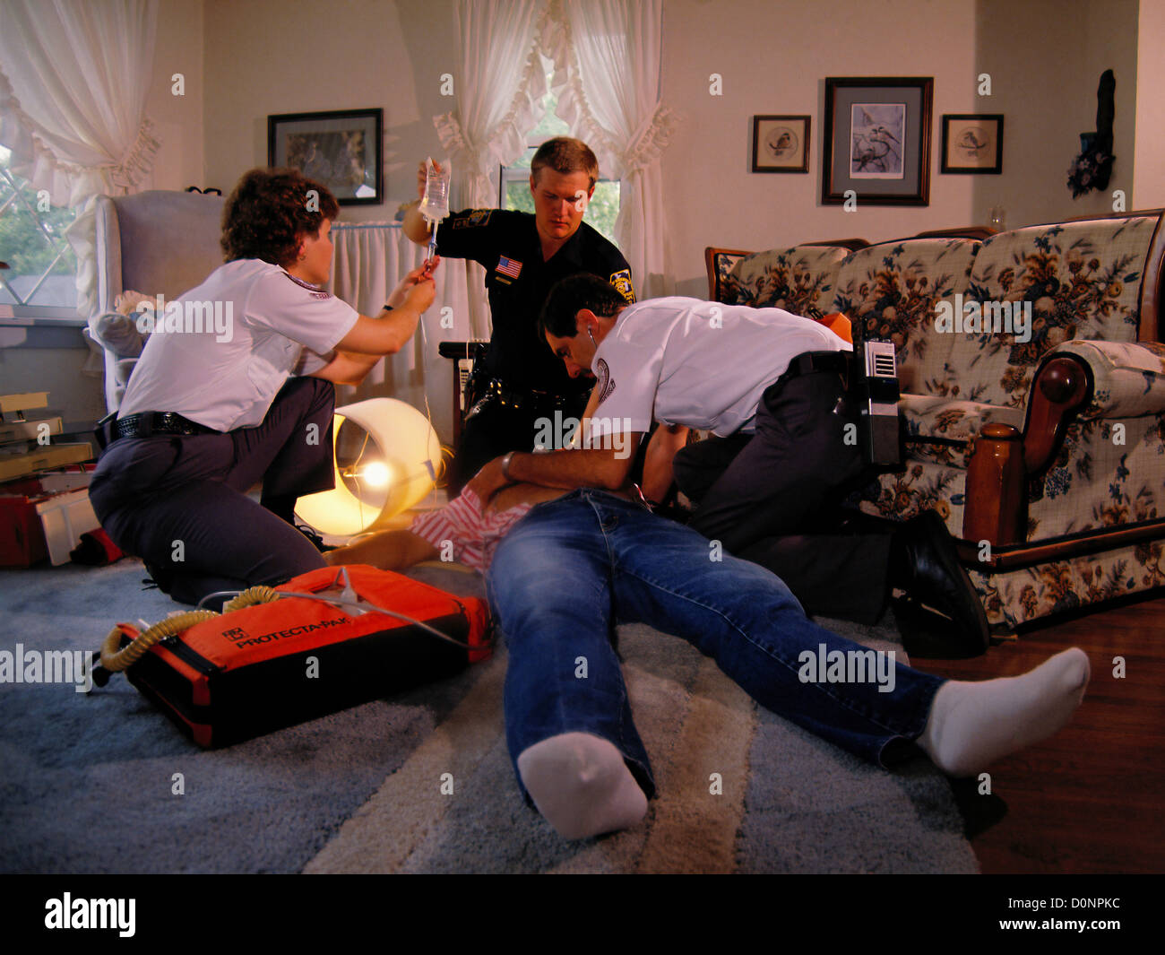 First Responders Help a Heart Attack Victim Stock Photo - Alamy