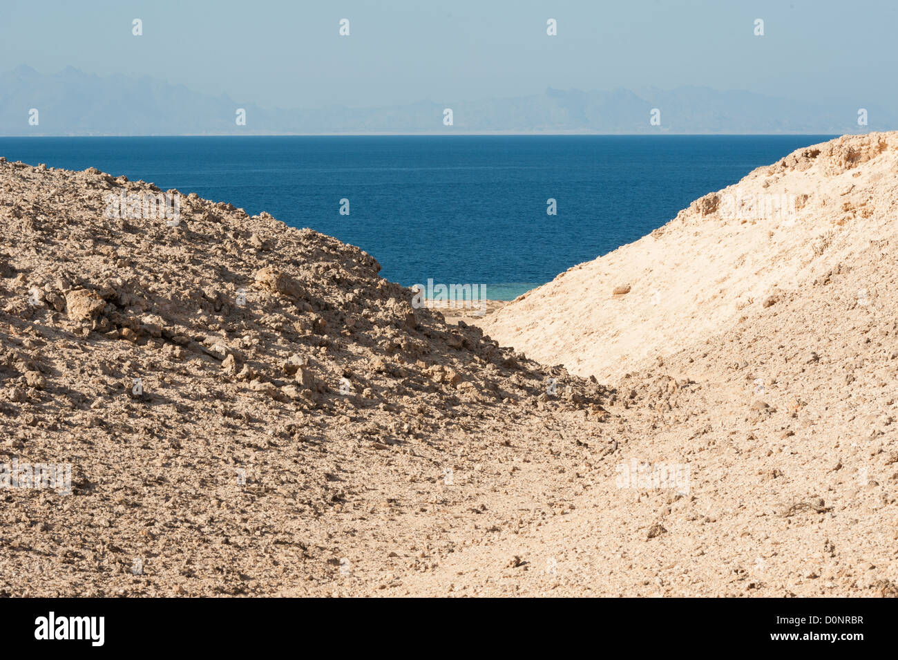 Small valley on a rocky desert island leading to the ocean Stock Photo ...