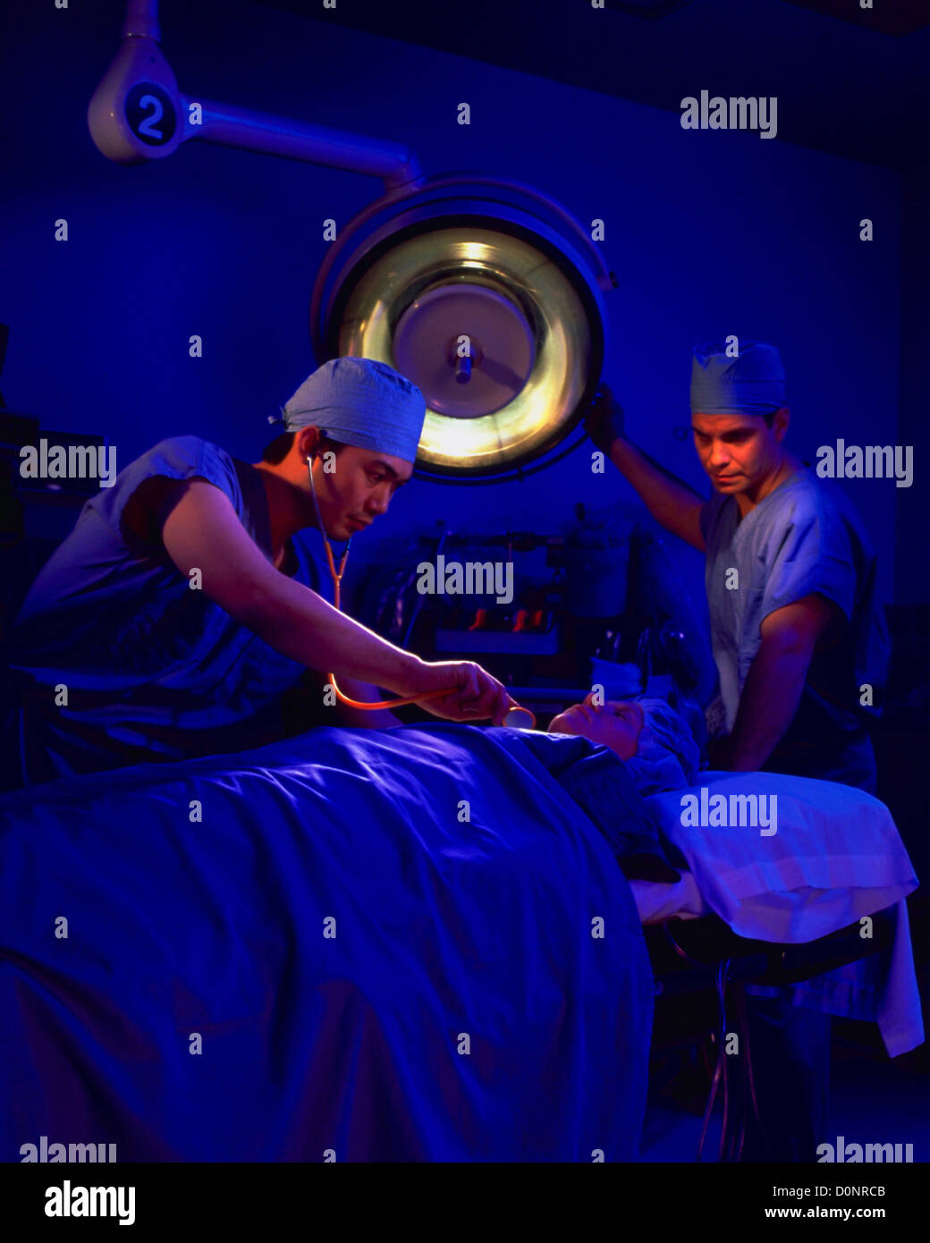 Doctor Checking on a Patient During Surgery as Another Looks On Stock ...