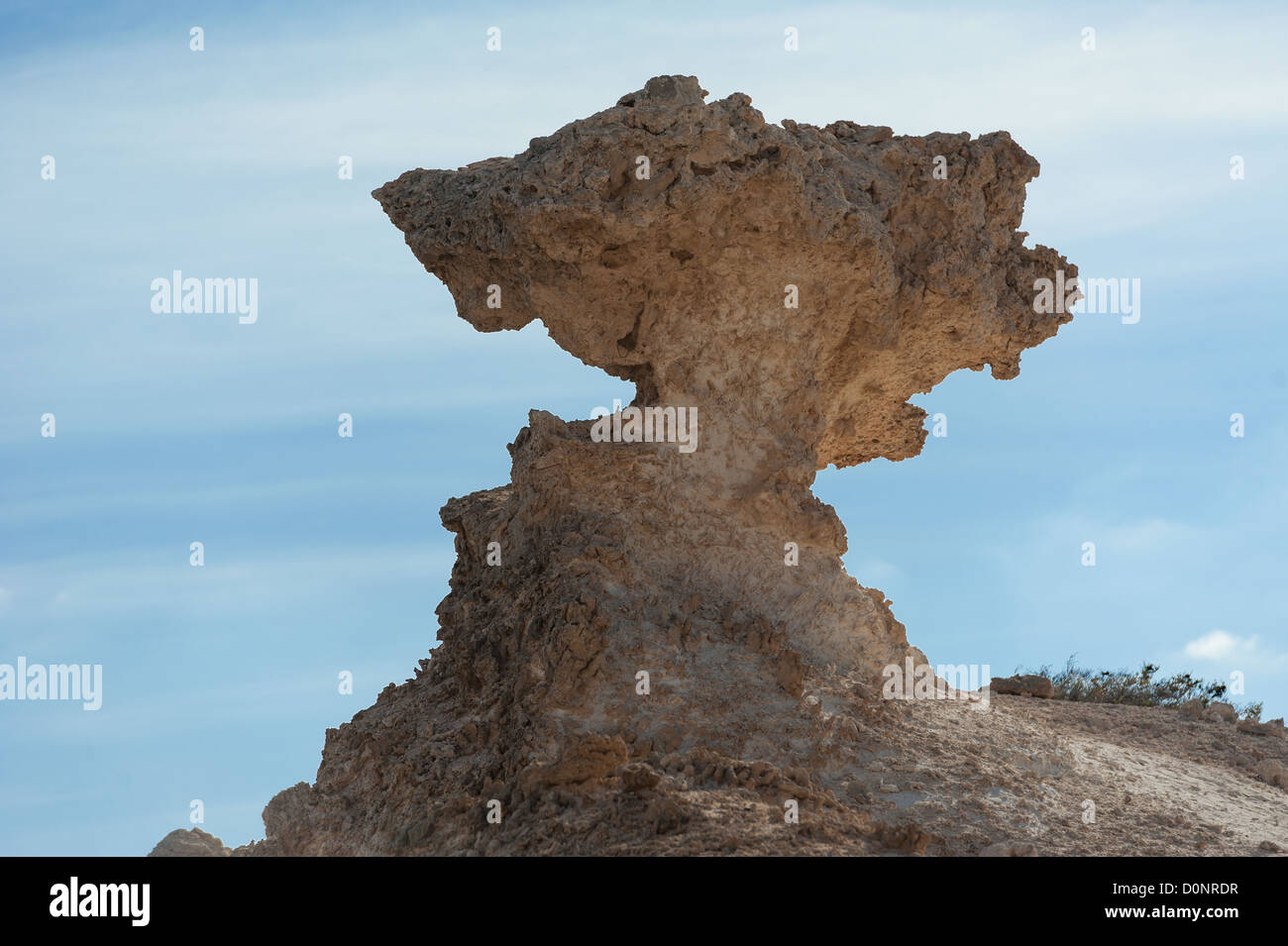 Abstract rock formation in the desert against a blue sky background ...