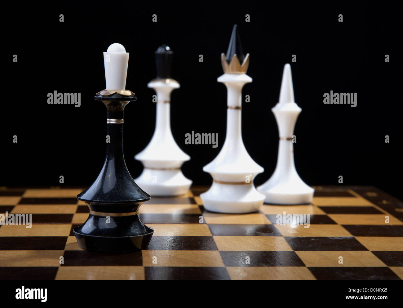 White figures checkmate to king Stock Photo - Alamy