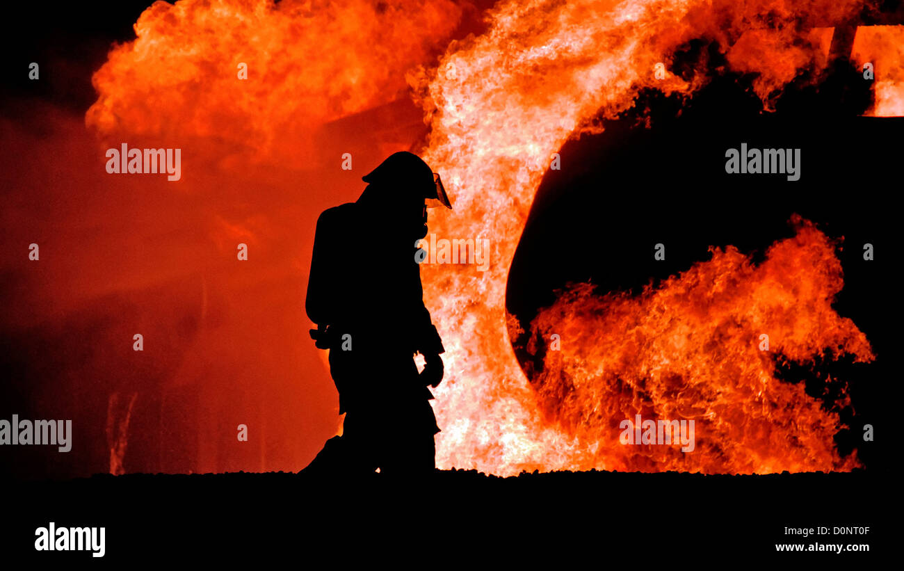 Firefighter and Flames Stock Photo - Alamy