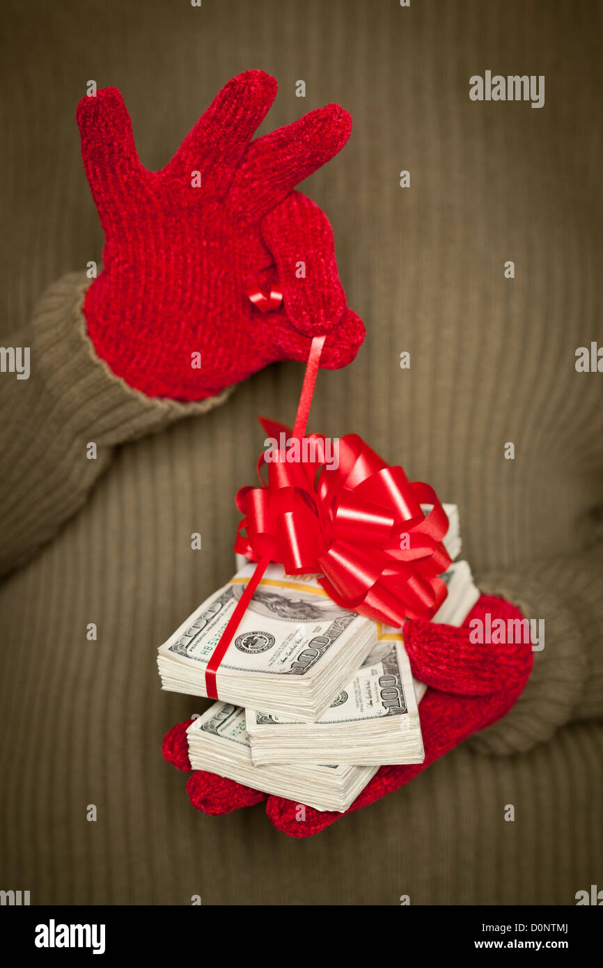 Woman Wearing Red Mittens and Green Sweater Holding Stacks of Hundreds ...