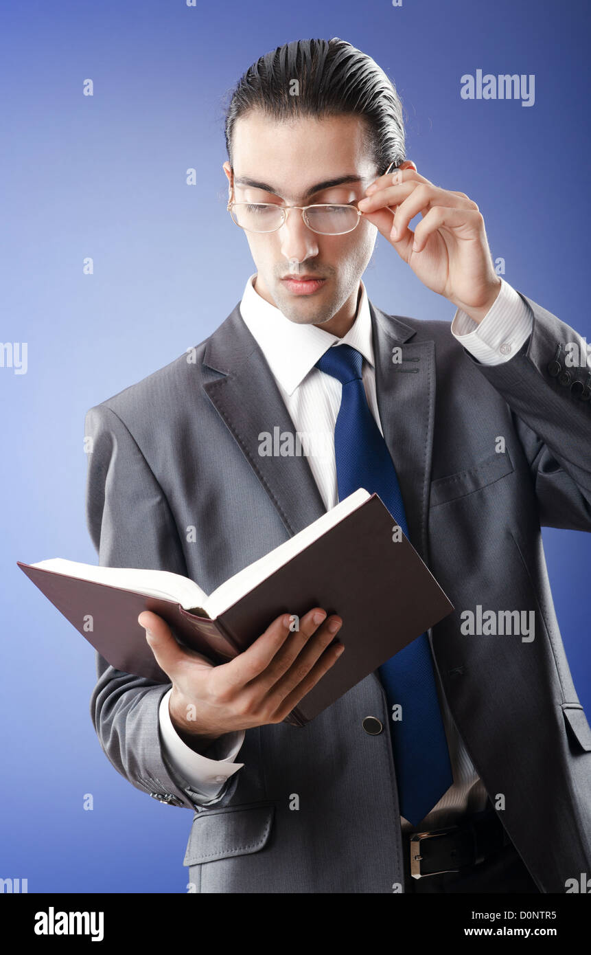 Businessman reading the book Stock Photo - Alamy