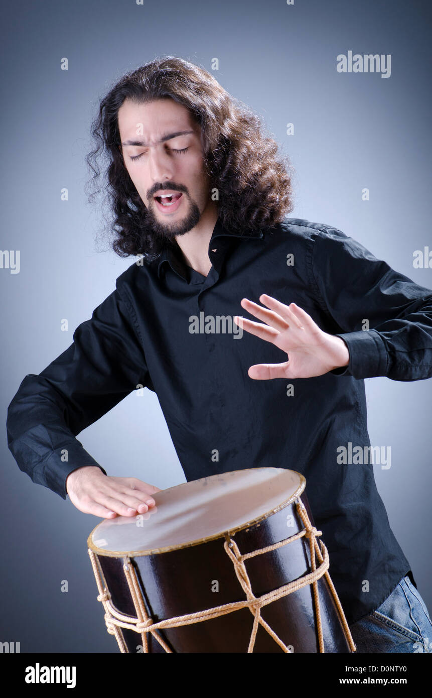 Man playing drum in studio Stock Photo - Alamy