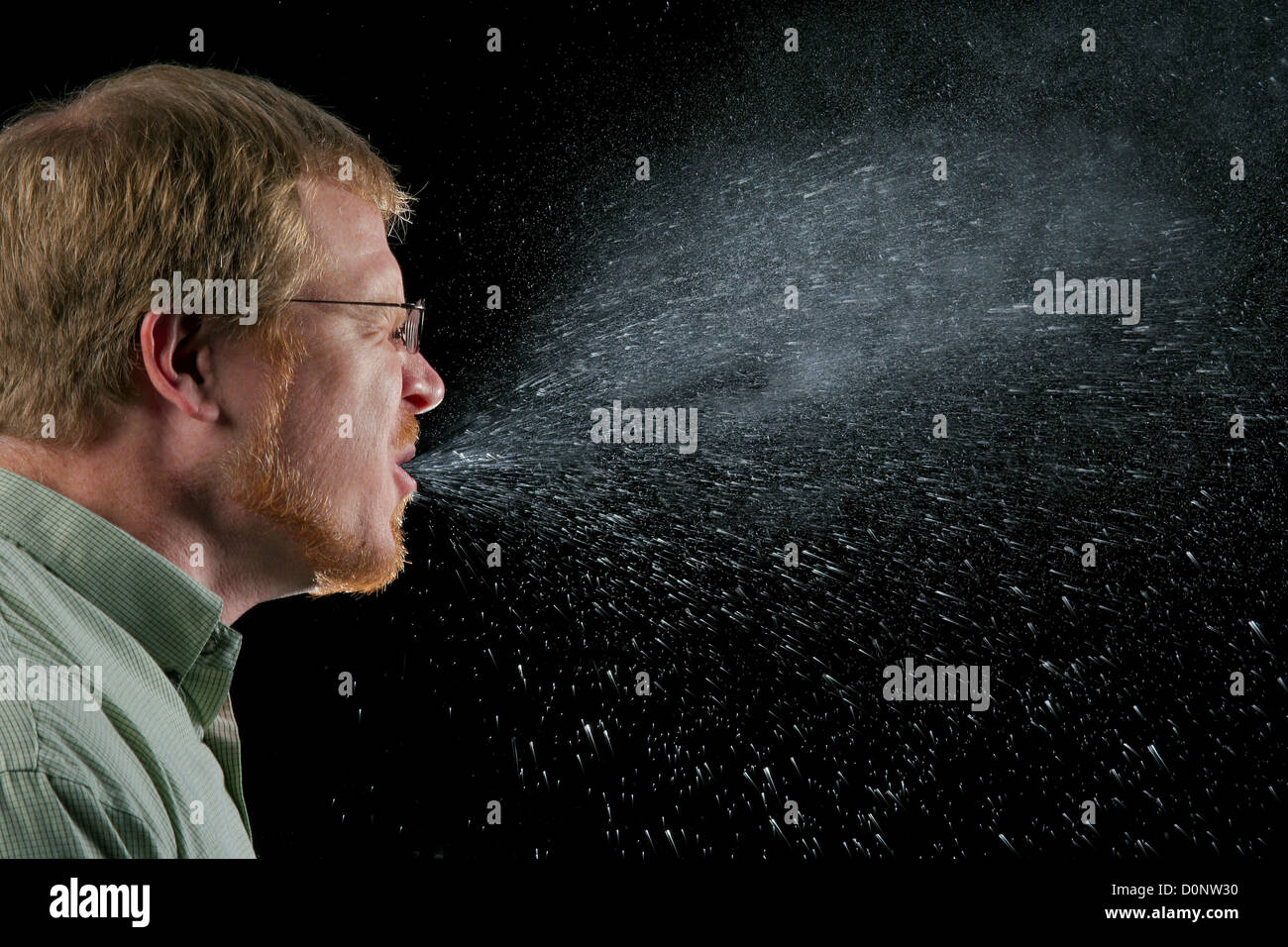 A sneeze in progress revealing plume salivary droplets as they are ...