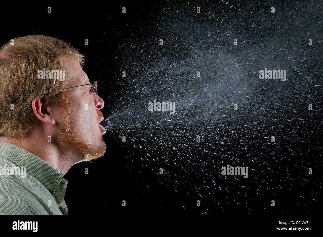 A sneeze in progress revealing plume salivary droplets as they are ...