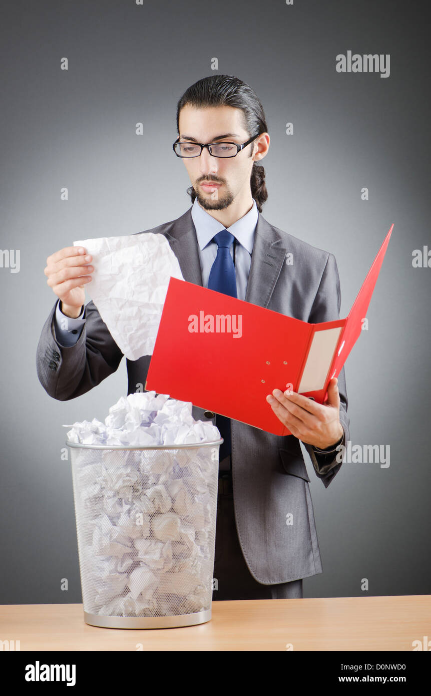Man with lots of wasted paper Stock Photo - Alamy