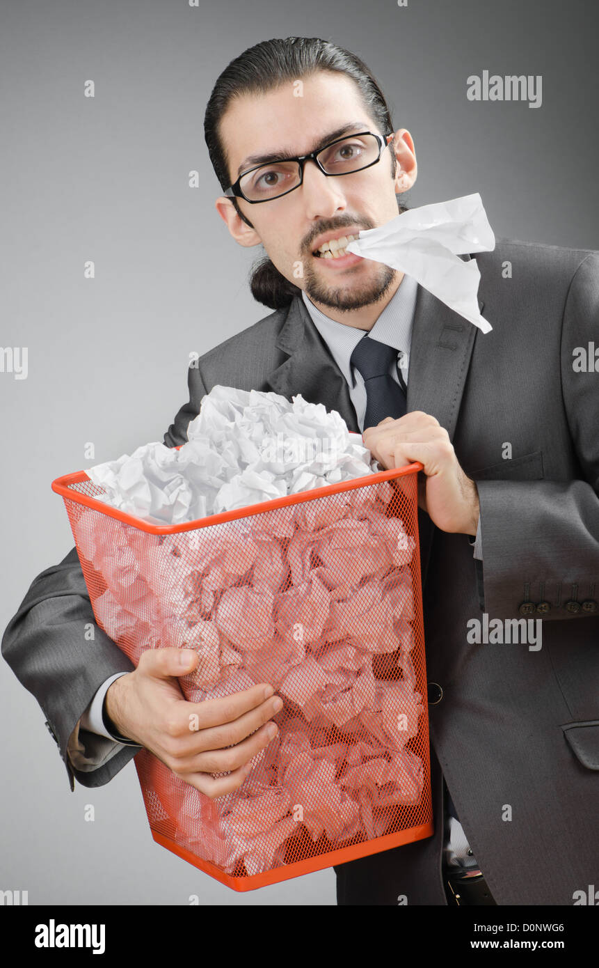 Man with lots of wasted paper Stock Photo - Alamy