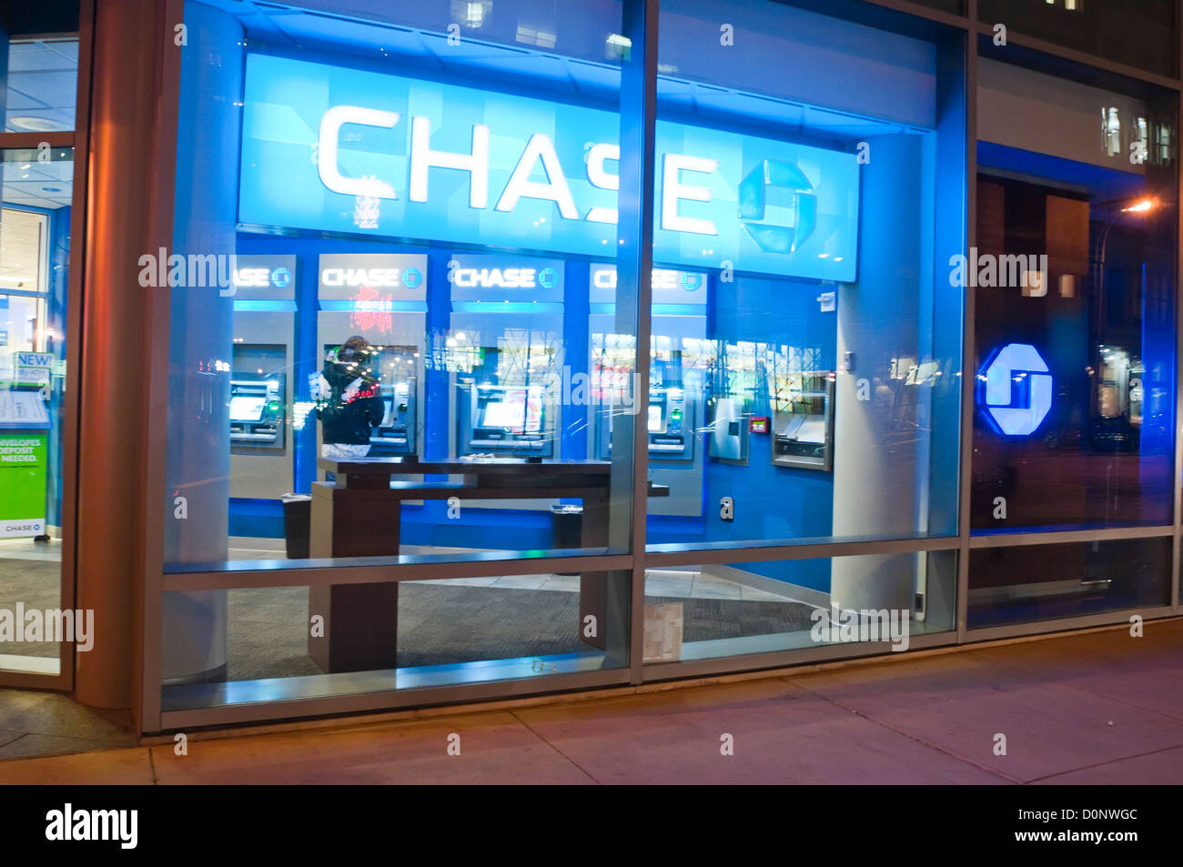 Man using a cash machine at night Stock Photo - Alamy