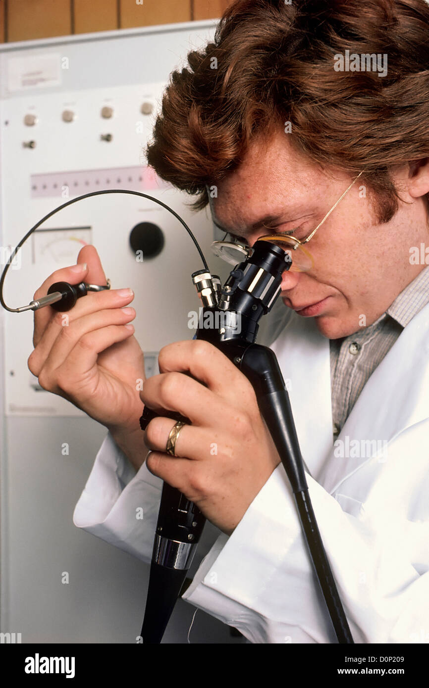 Doctor looking through endoscope hi-res stock photography and images ...