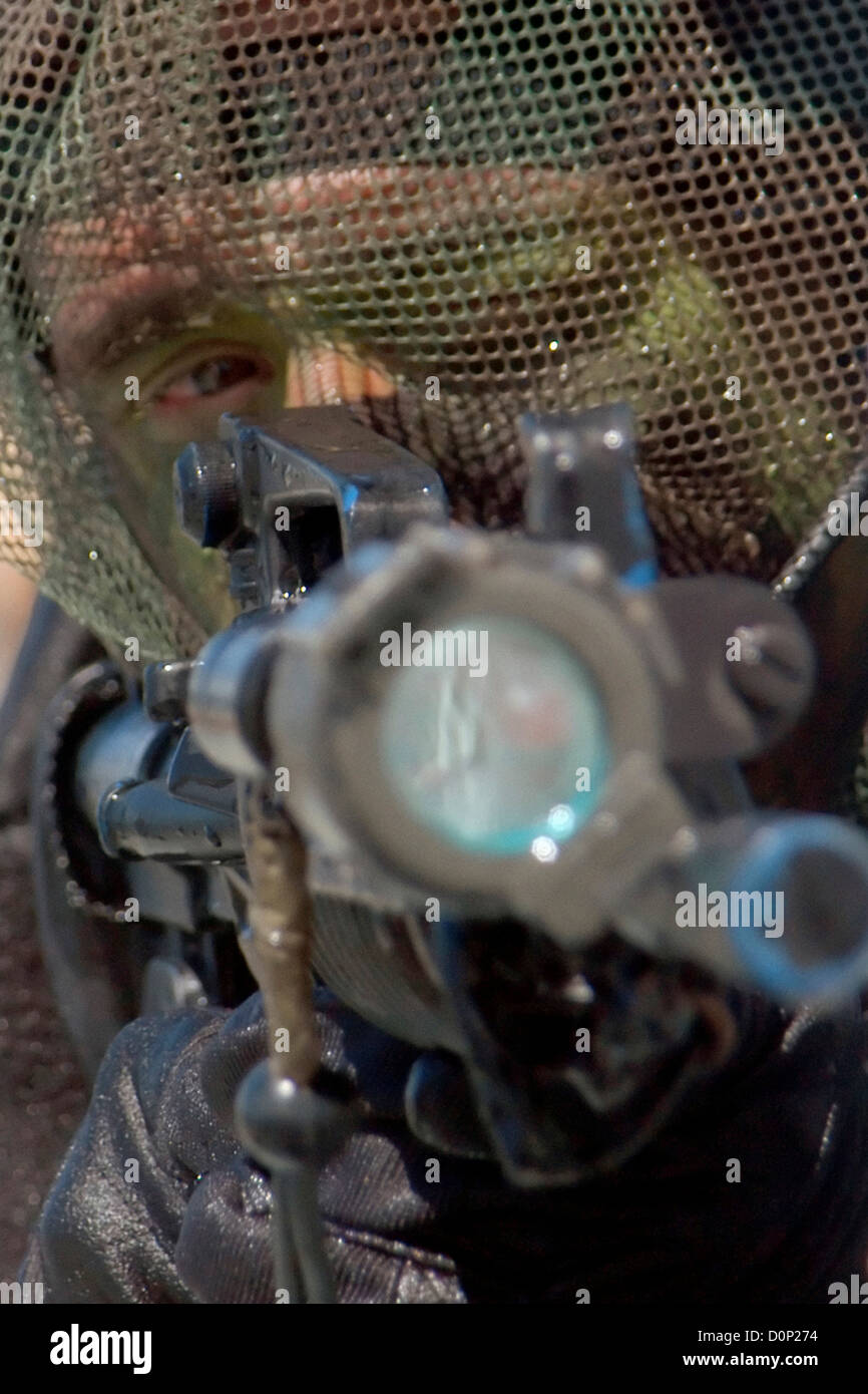 Aiming Rifle Through Camouflage Stock Photo - Alamy