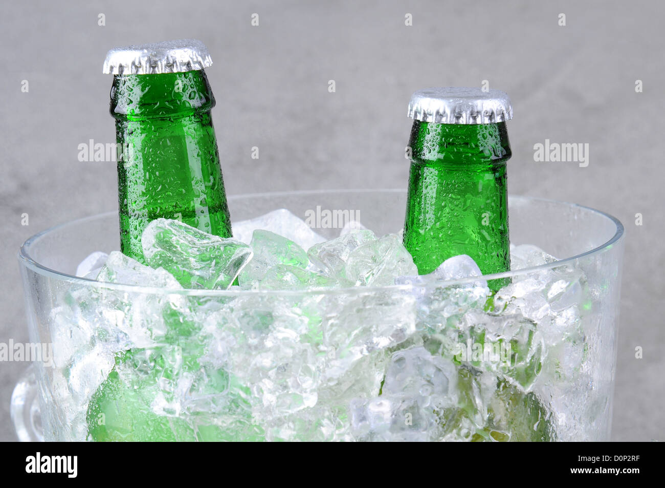 Closeup of two green beer bottles in a crystal ice bucket. Horizontal ...