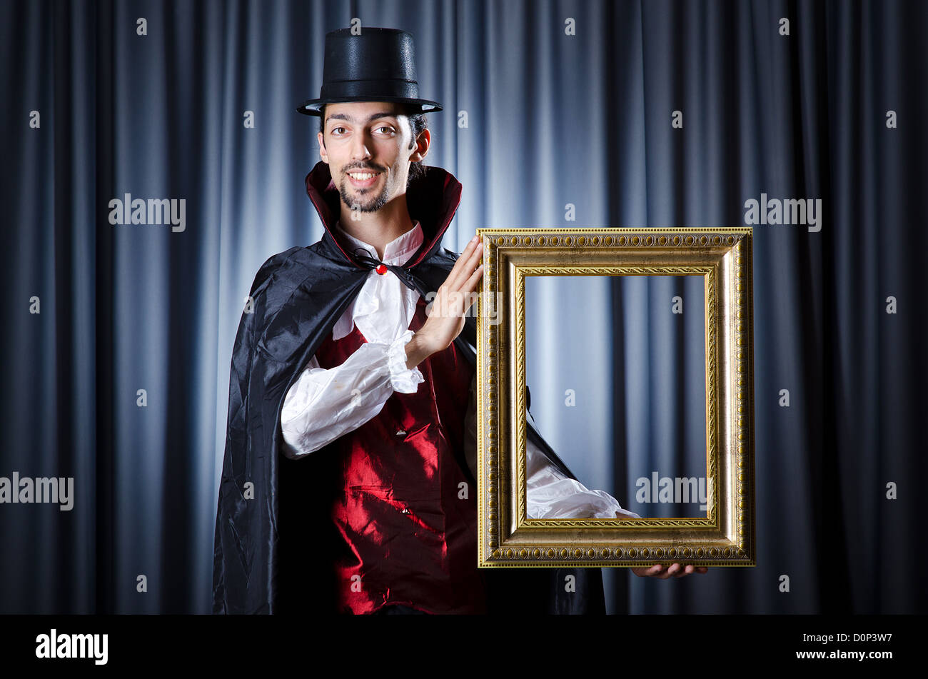 Magician with photoframe in studio Stock Photo - Alamy