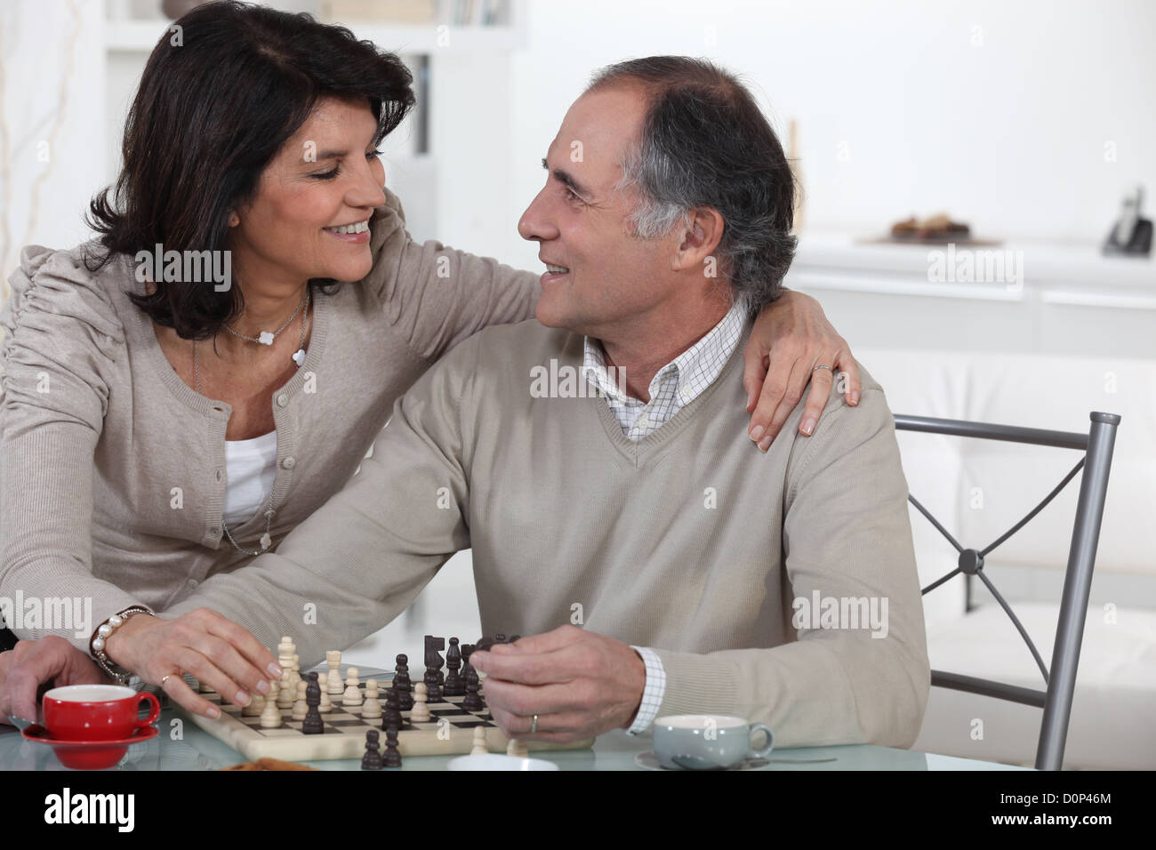 Married couple playing chess at home Stock Photo - Alamy