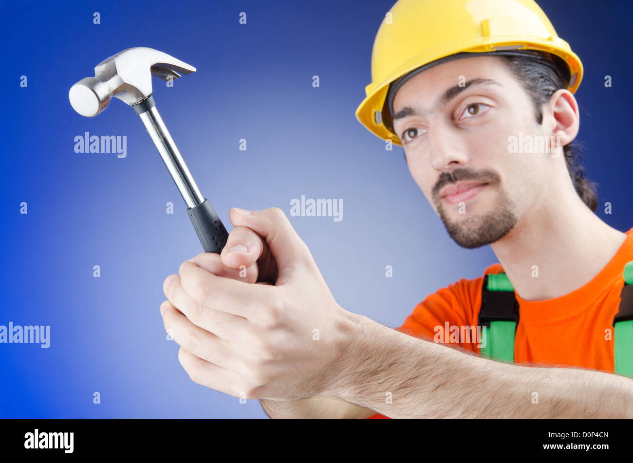Man with hammer in studio Stock Photo - Alamy