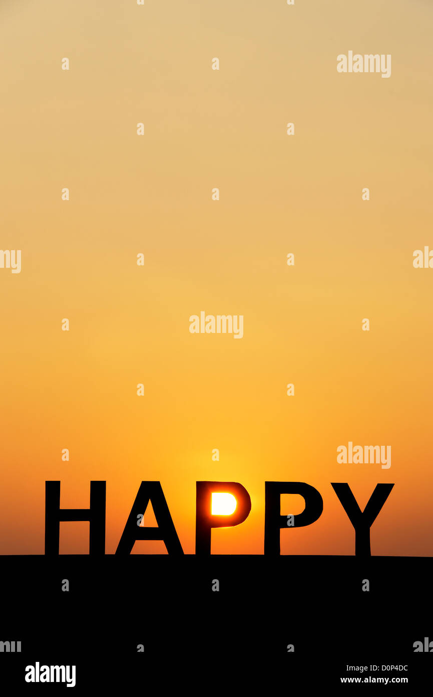 HAPPY letters silhouette at sunset Stock Photo - Alamy
