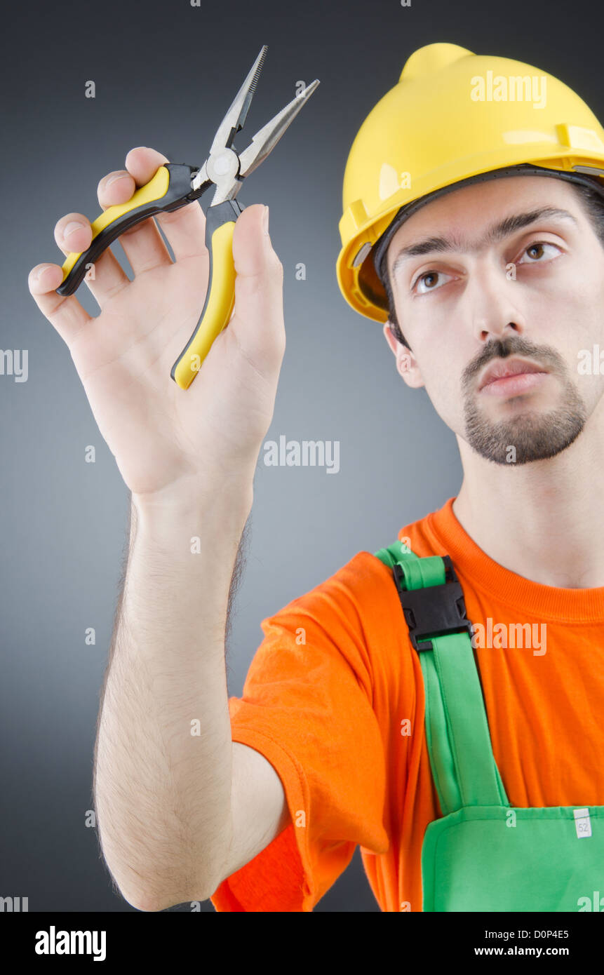 Man with tongs in studio Stock Photo - Alamy