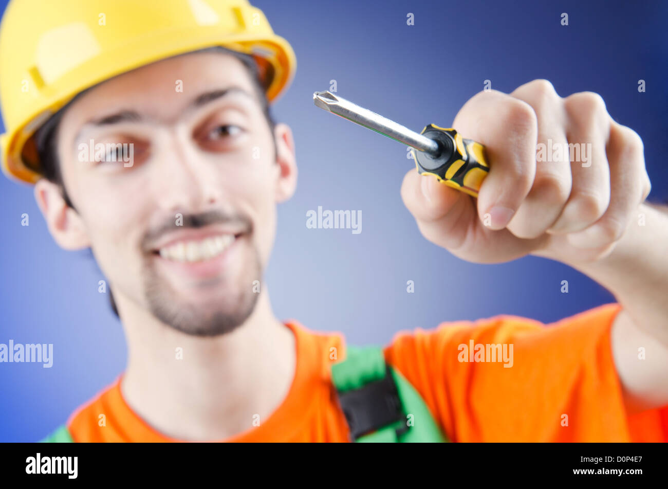 Man with a screwdriver in studio Stock Photo - Alamy