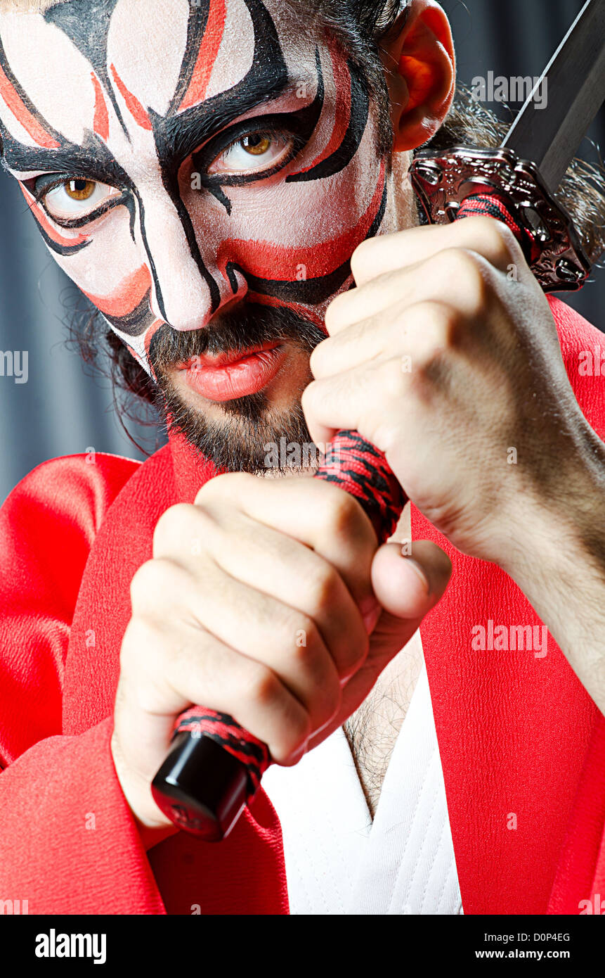Man with face mask and sword Stock Photo - Alamy