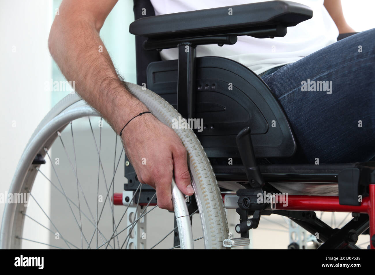 Closeup of a man's hand on the wheel of his wheelchair Stock Photo - Alamy
