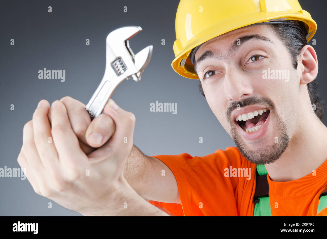 Man with a wrench in a studio Stock Photo - Alamy