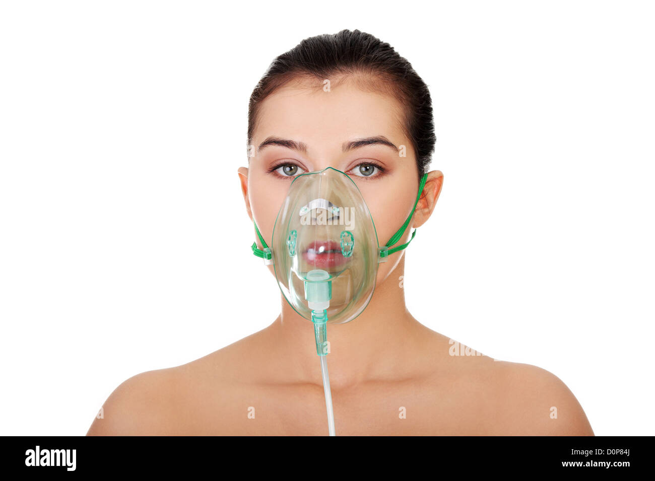 Diseased female patient wearing a oxygen mask against white background ...