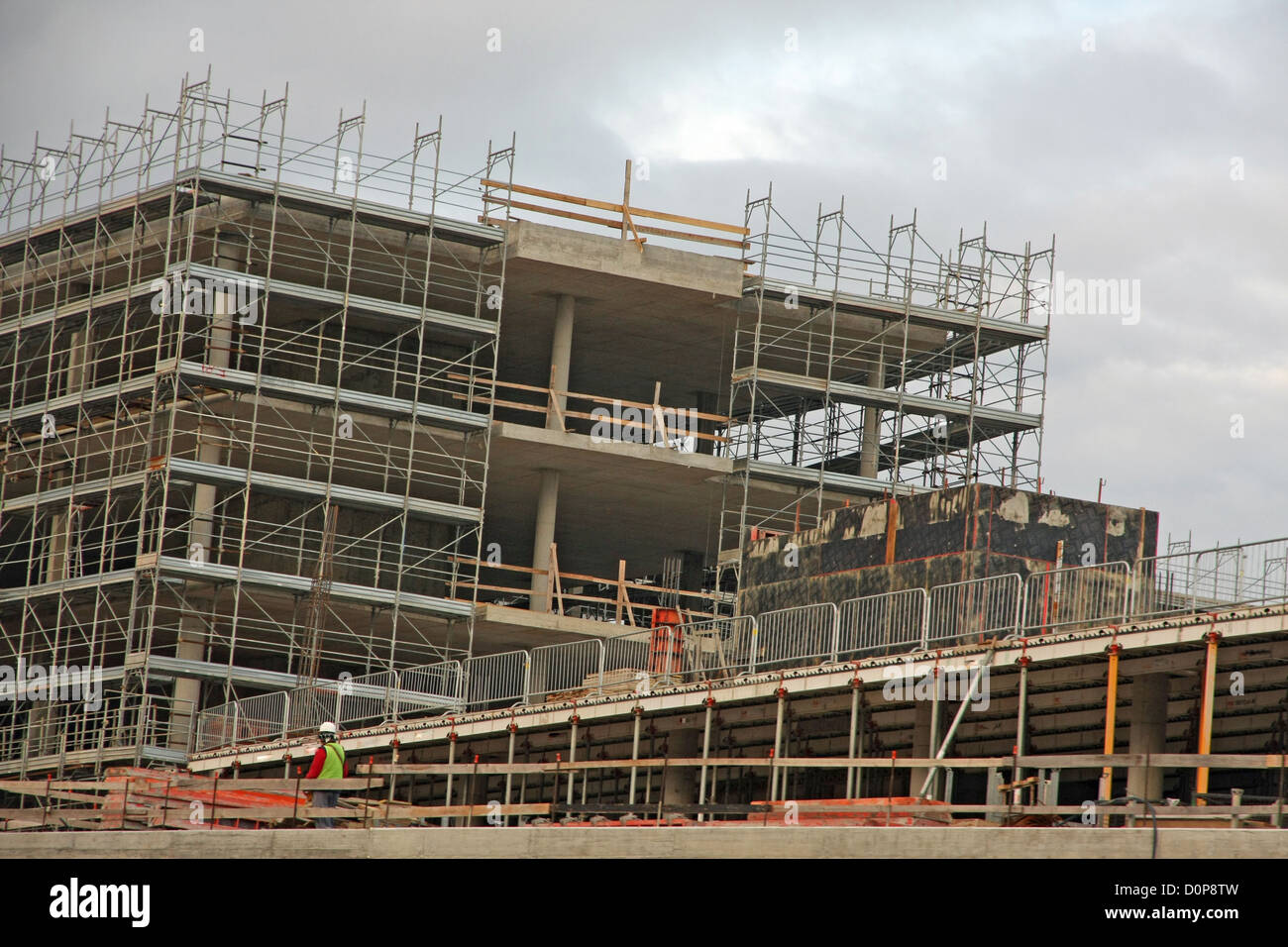 many scaffolding n a construction site of a large concrete building ...
