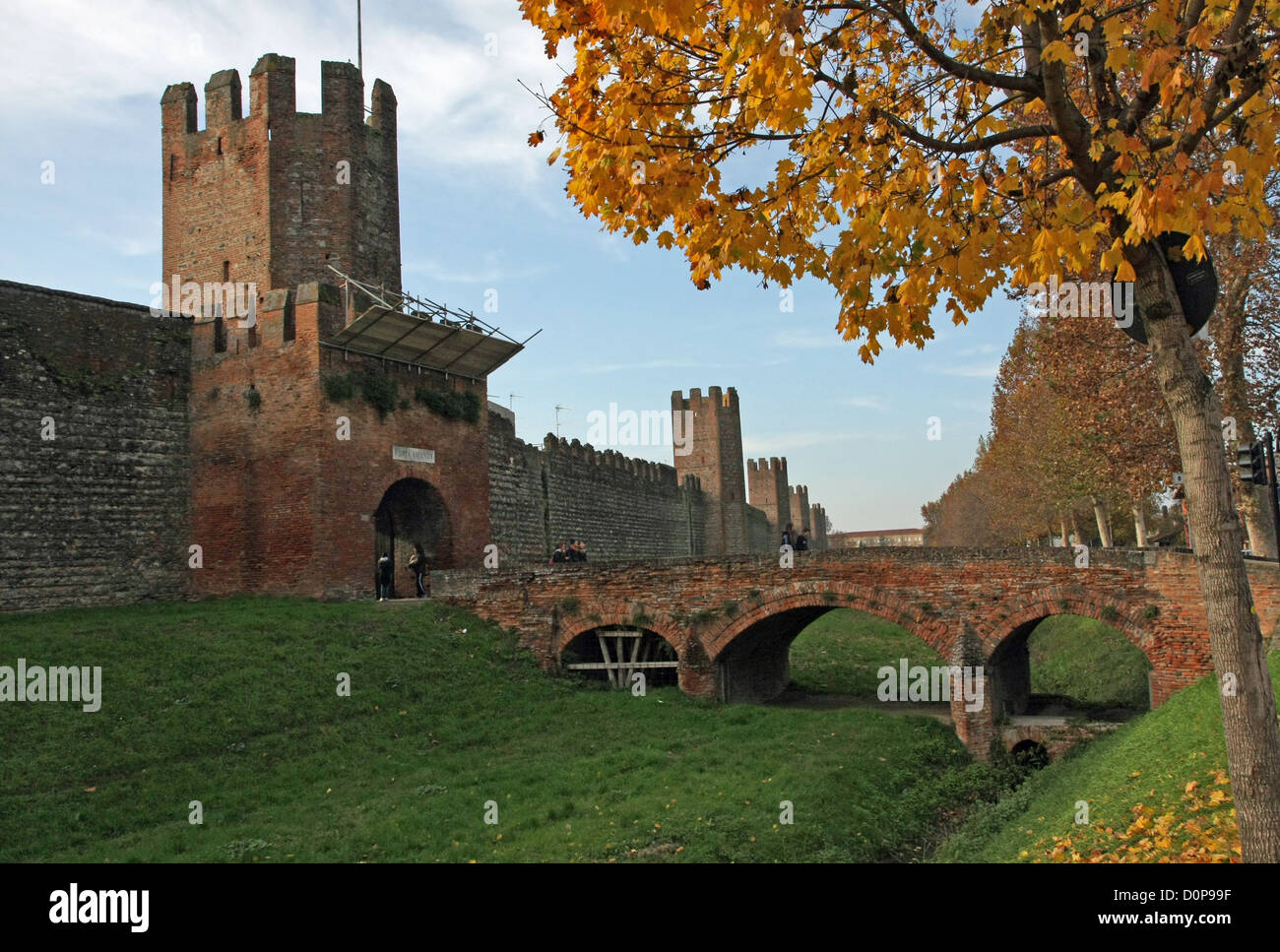 walls and towers and red brick bridge of an ancient medieval castle in ...