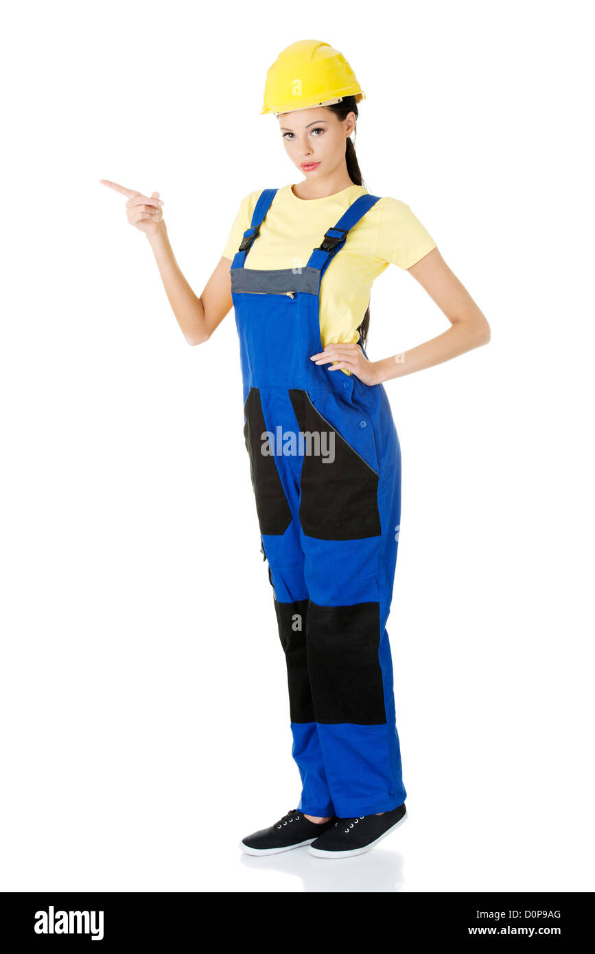 Female construction worker pointing on copy space, isolated on white ...