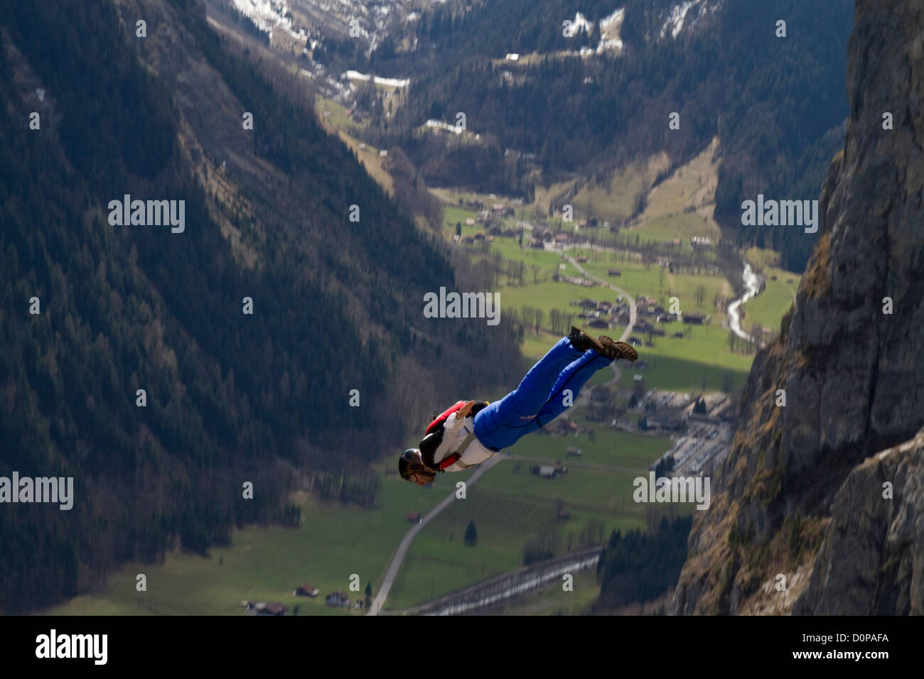 This BASE jumper is proximity tracking down the valley after he exiting ...