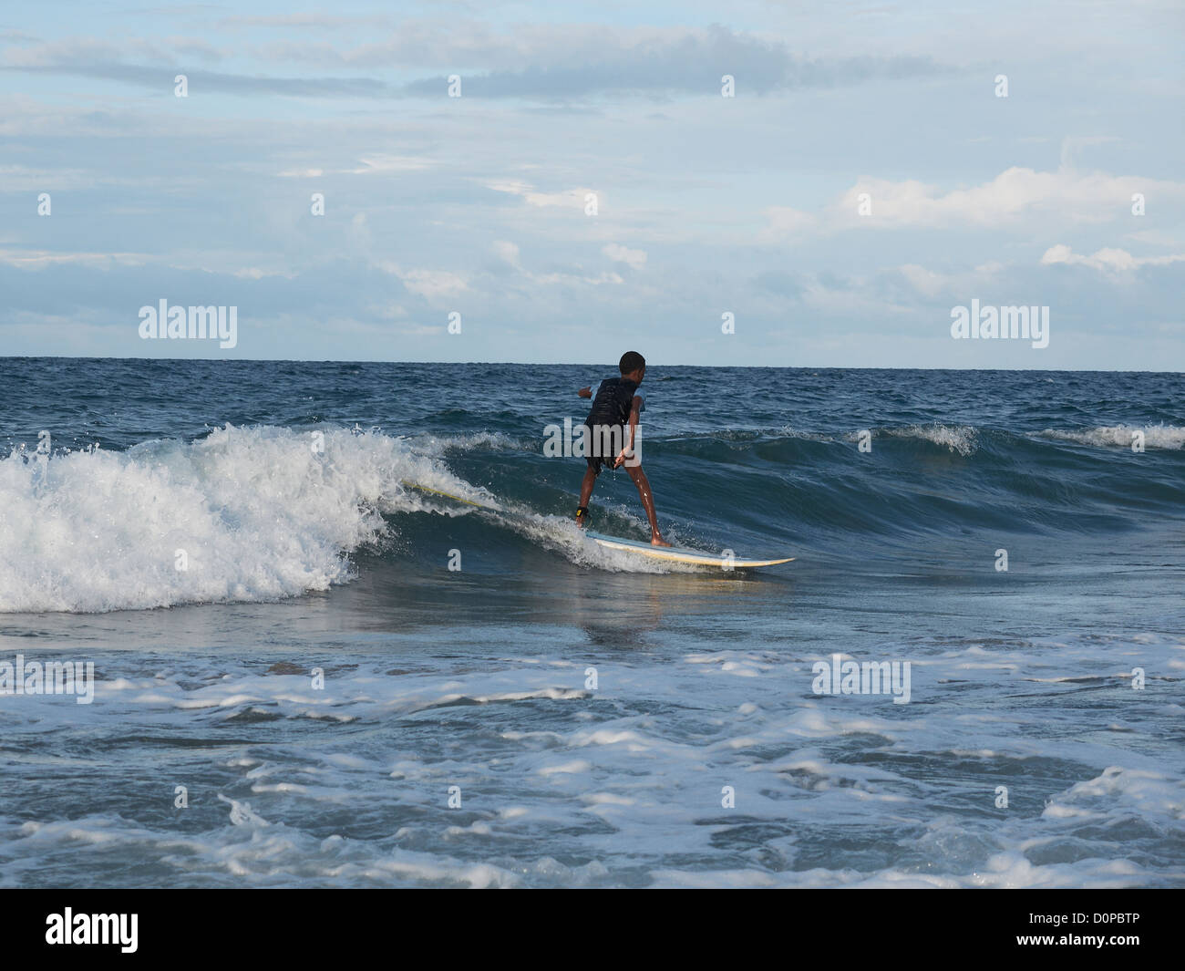 indigenous boy surfing on a wave,Puerto Viejo de Talamanca; Costa Rica ...