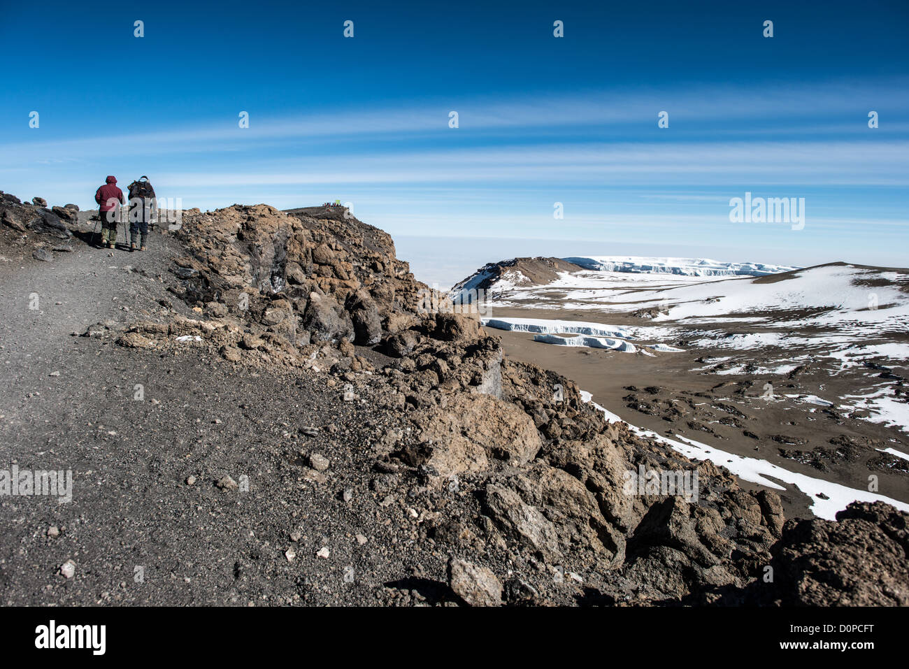 MOUNT KILIMANJARO, Tanzania — Two hikers approach Uhuru Peak, the highest point on Mount ...