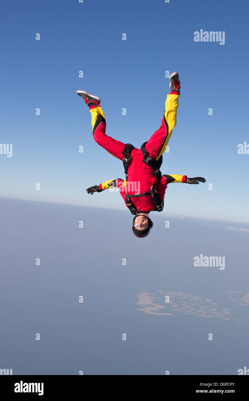 Skydiver girl is flying free over the Dubai earth and performance a ...