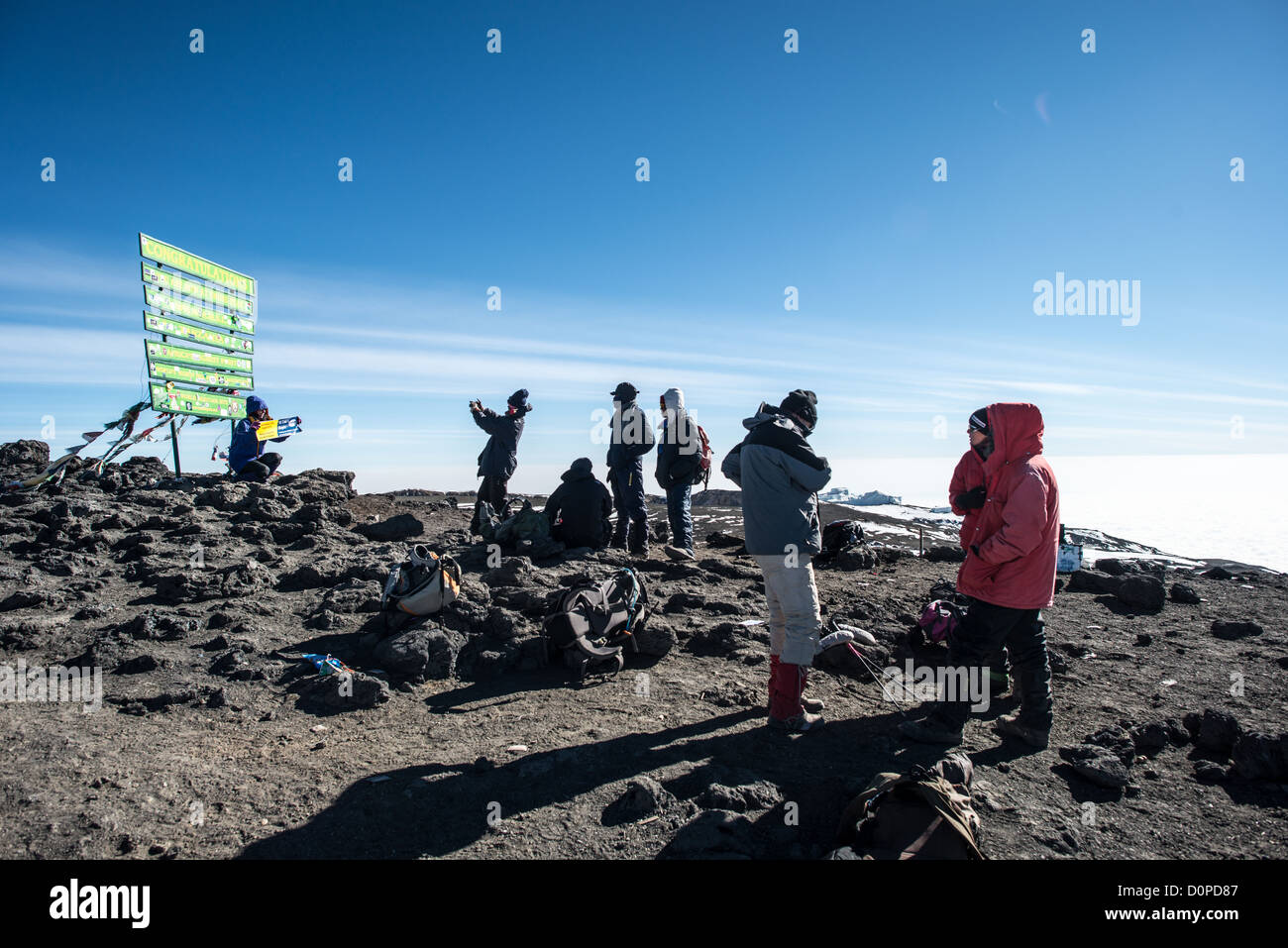 MOUNT KILIMANJARO, Tanzania — Climbers pose for photos next to the sign marking Uhuru Peak, the ...