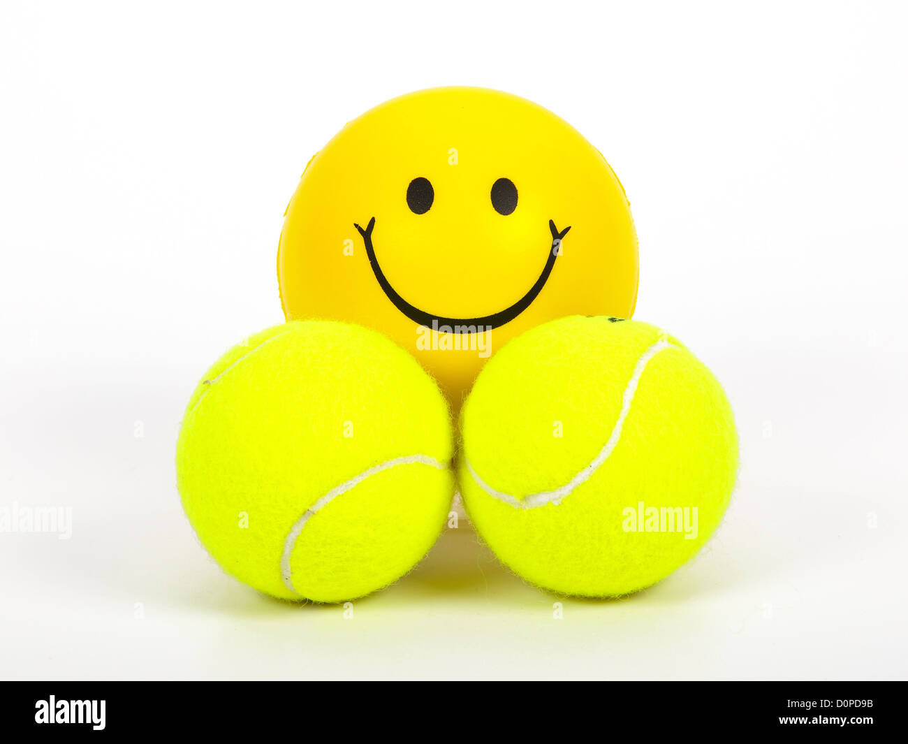smiling tennis ball and two normal balls Stock Photo - Alamy
