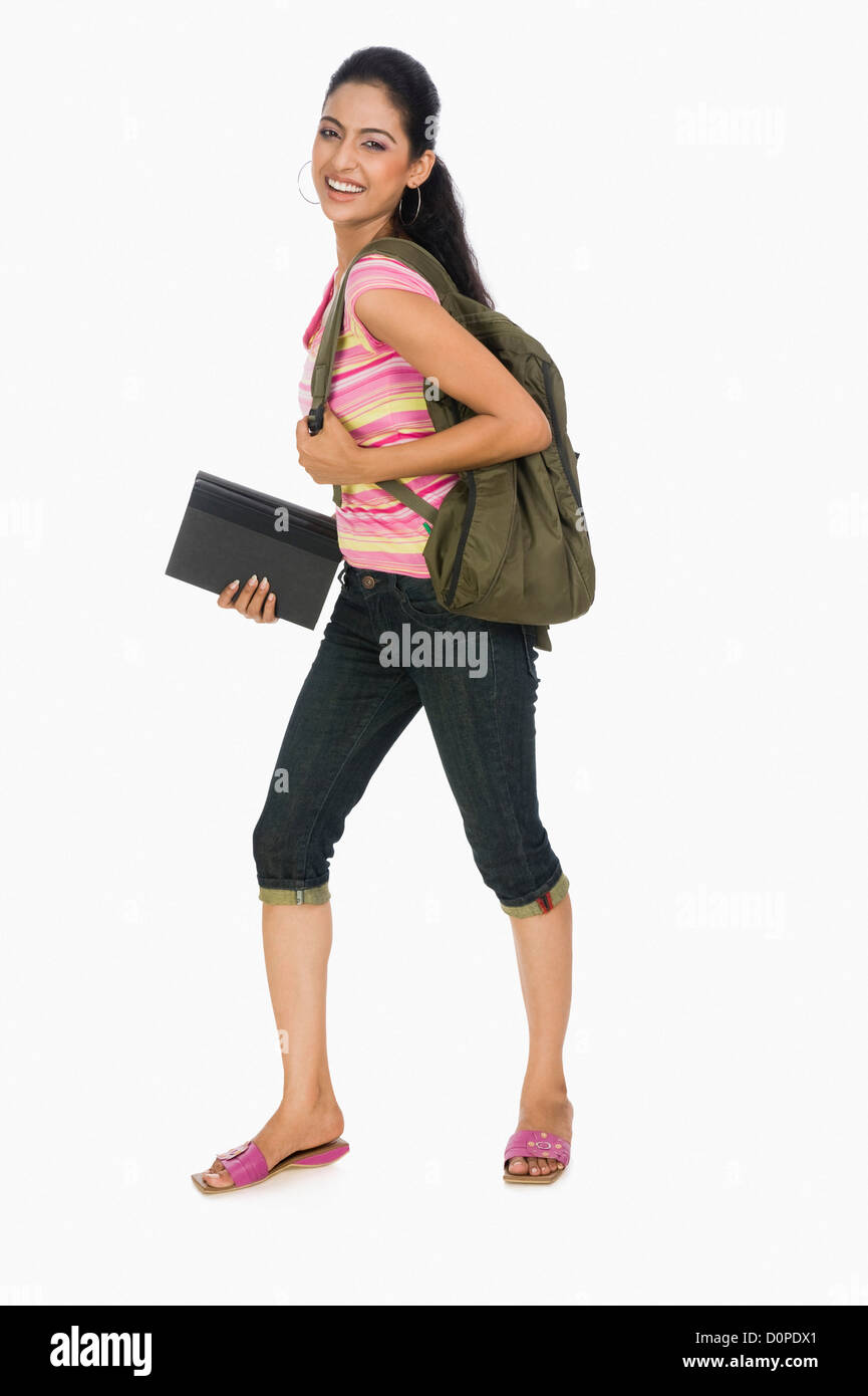 Portrait of a university student carrying a bag and books Stock Photo ...