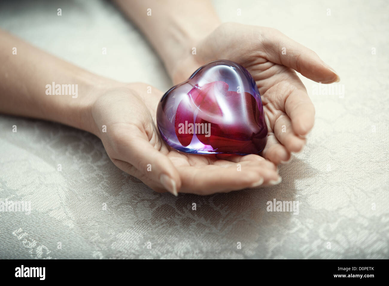 Woman hands holding heart shape object Stock Photo - Alamy