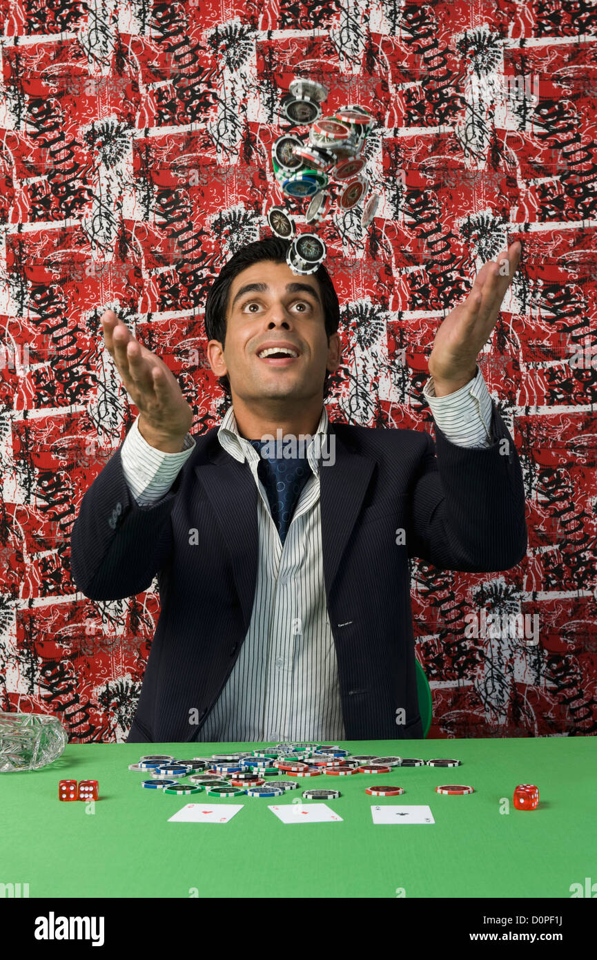 Man tossing gambling chips in a casino Stock Photo - Alamy