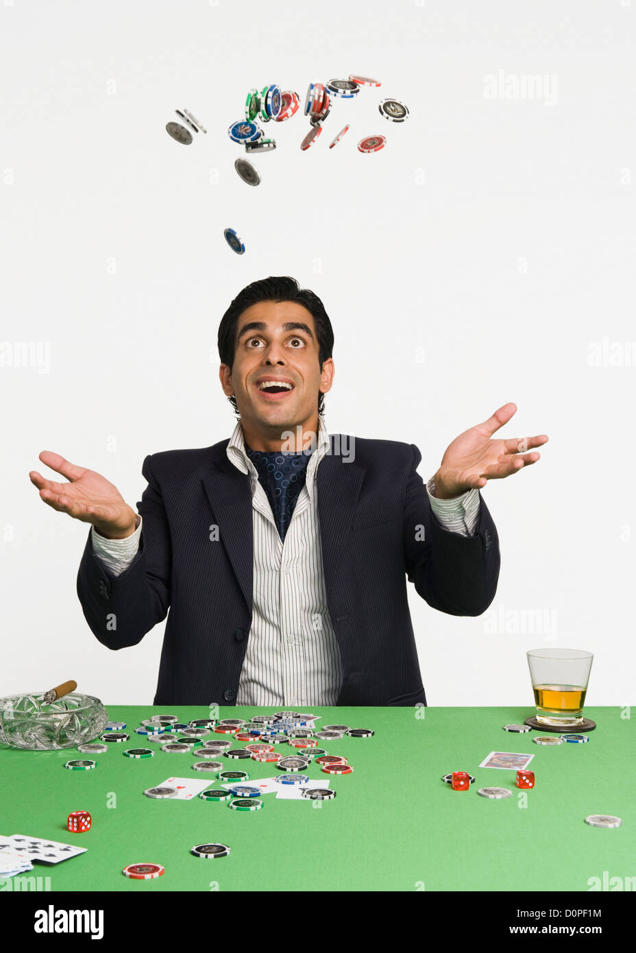 Man tossing gambling chips in a casino Stock Photo - Alamy