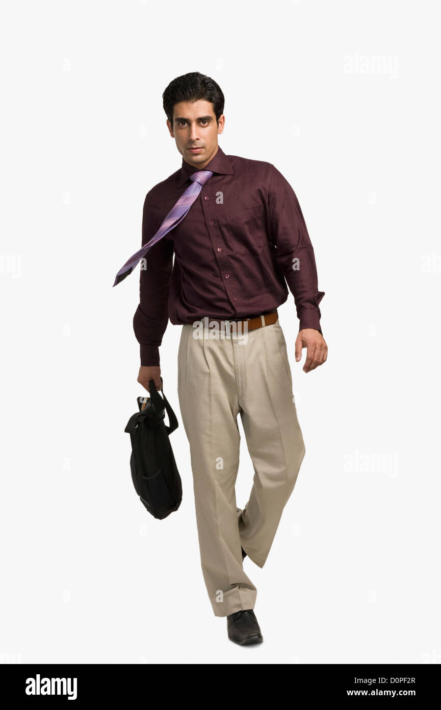 Portrait of a businessman pulling a bag Stock Photo - Alamy