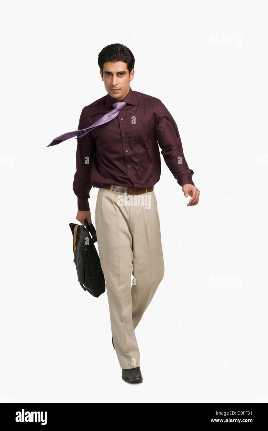 Portrait of a businessman pulling a bag Stock Photo - Alamy