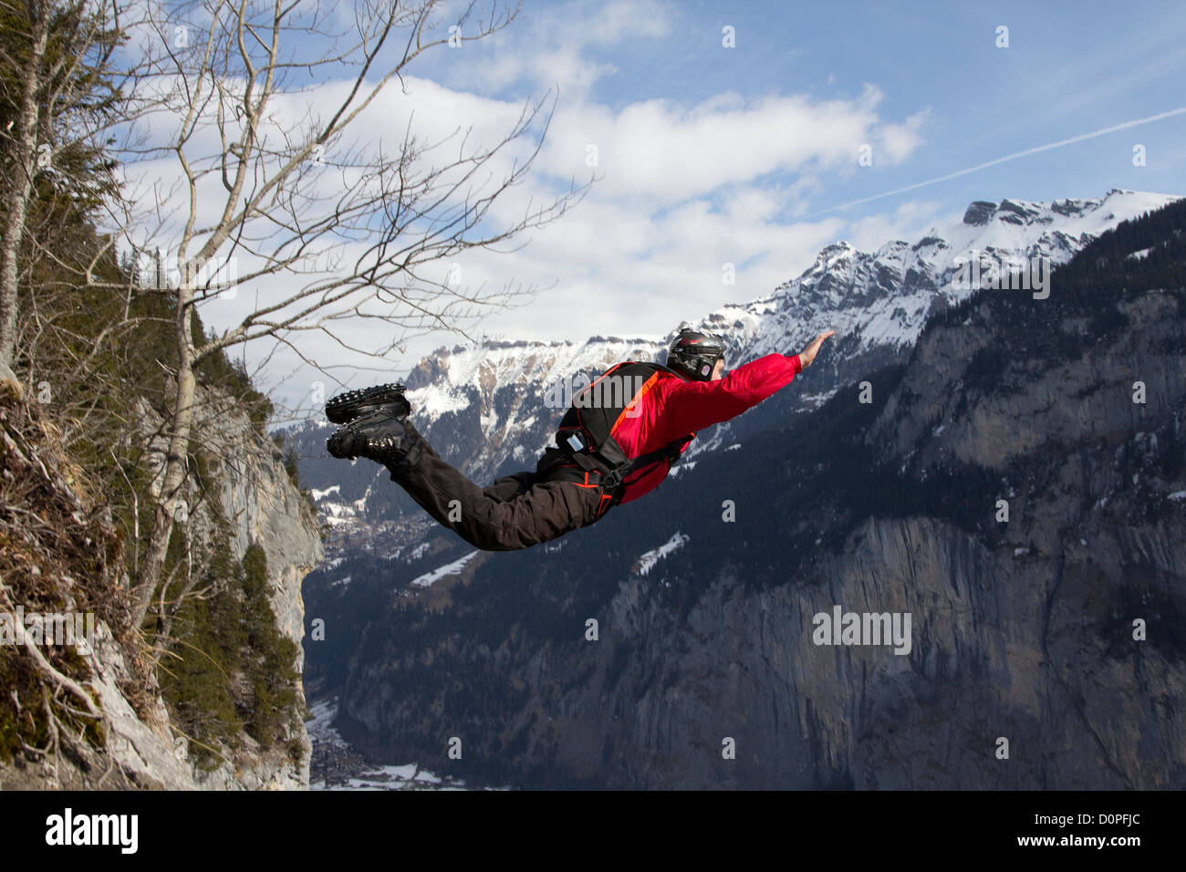 Man is jumping from a cliff down into the valley. He was very nervous ...