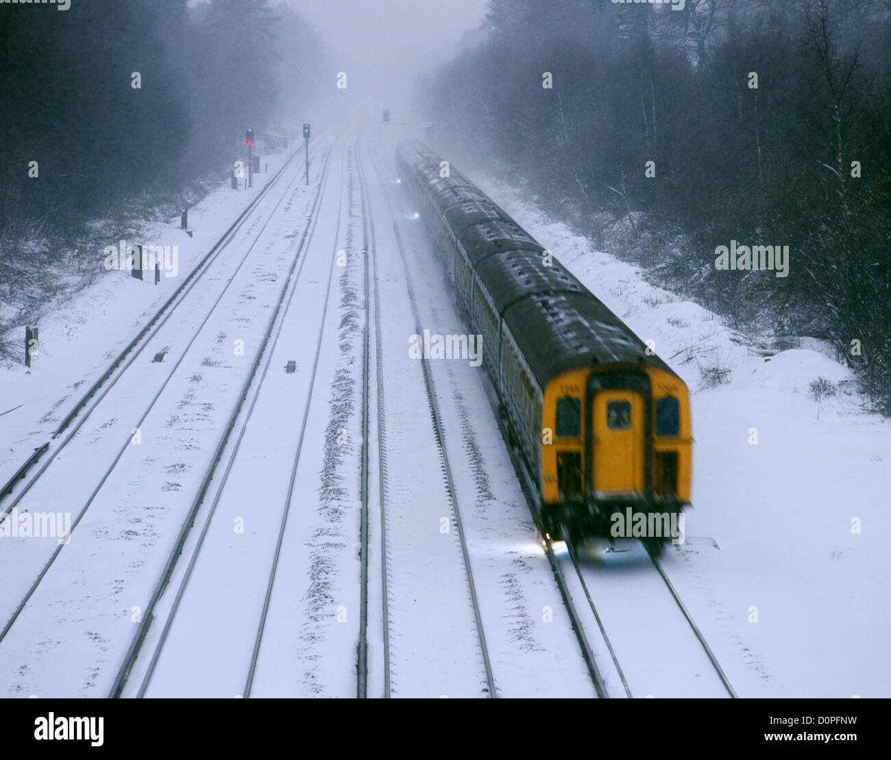 Train on snow covered tracks. England Stock Photo - Alamy