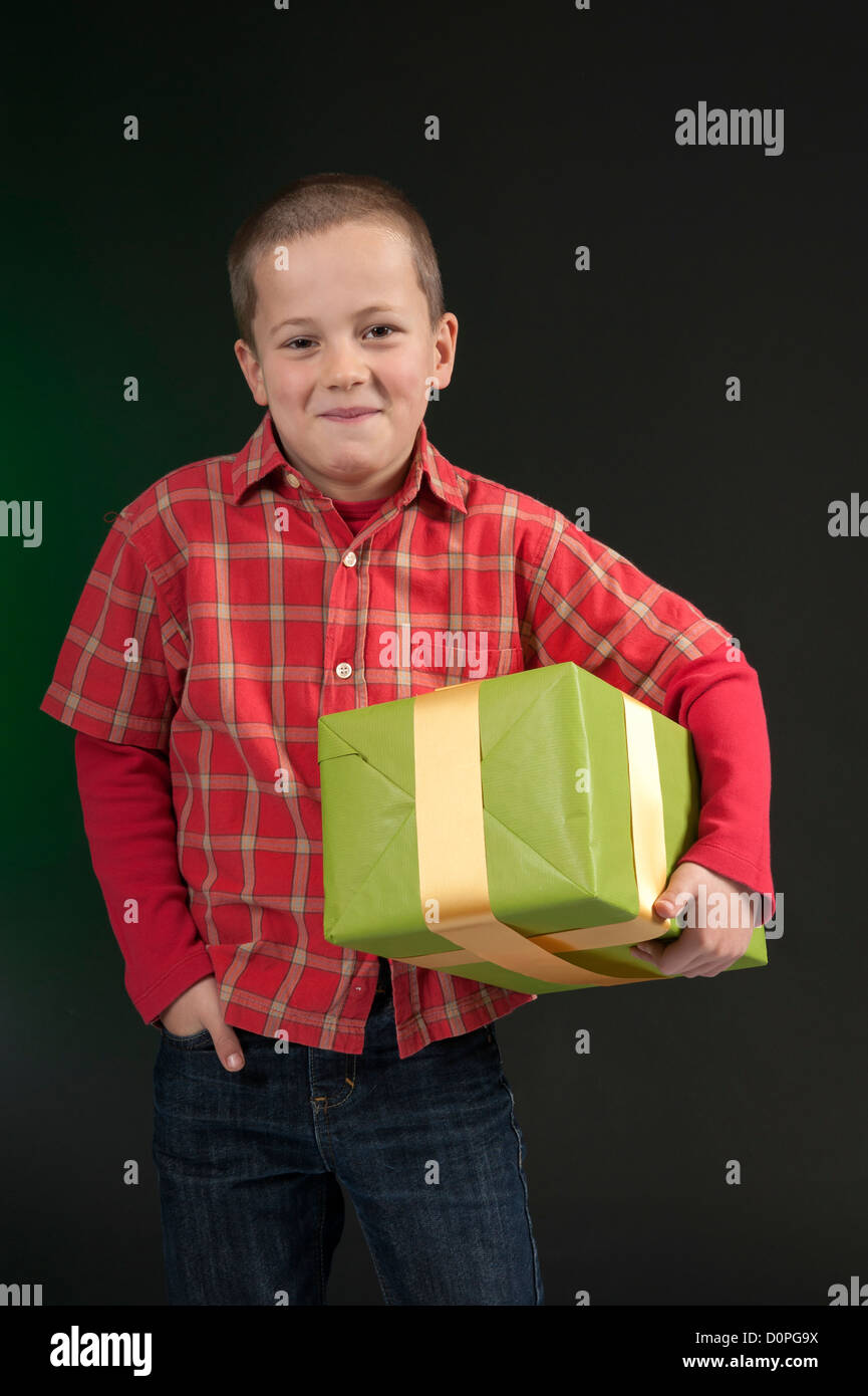 boy with present on dark green background Stock Photo - Alamy