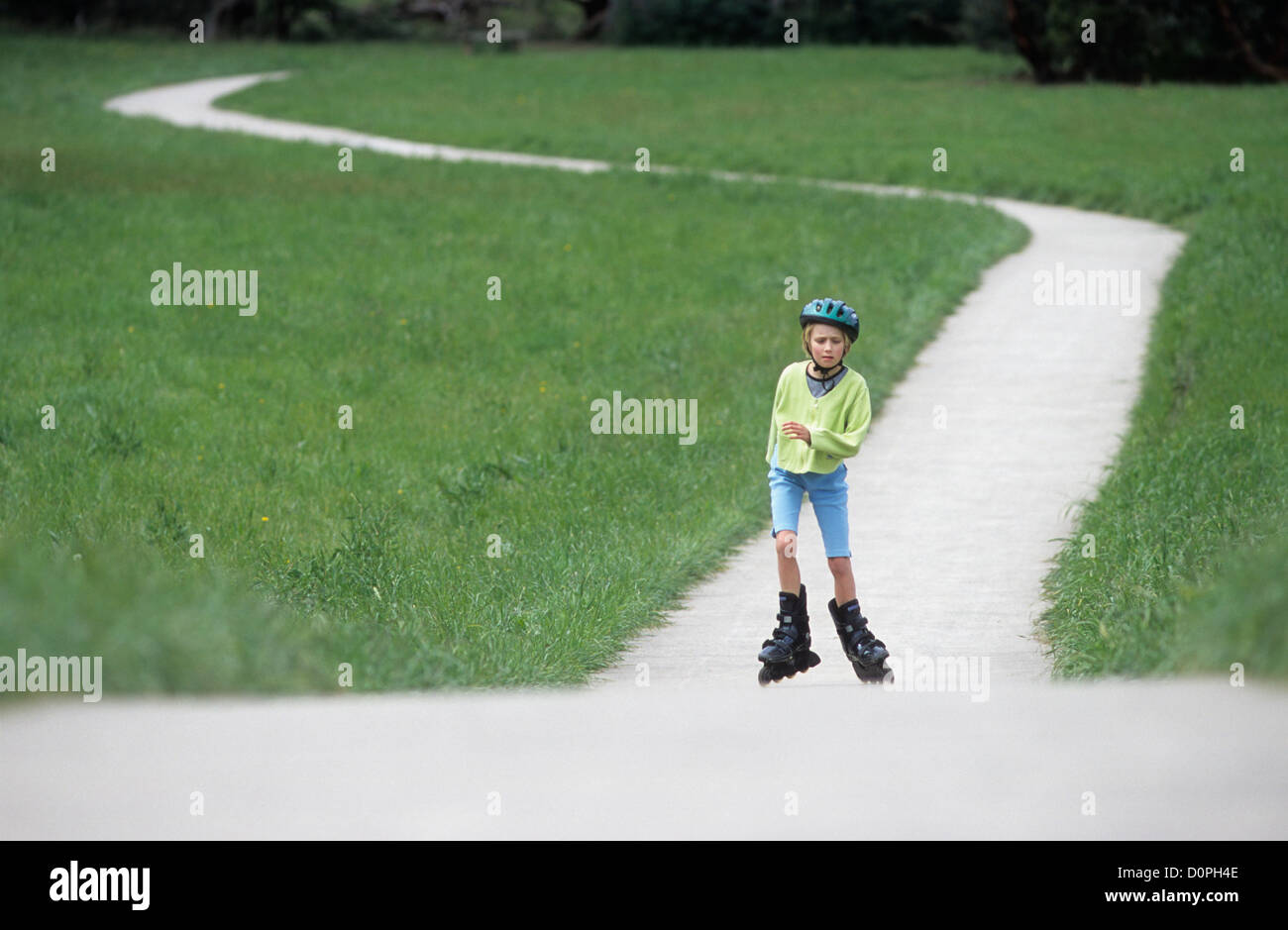 Children, girl aged 9 roller blading on path Stock Photo - Alamy