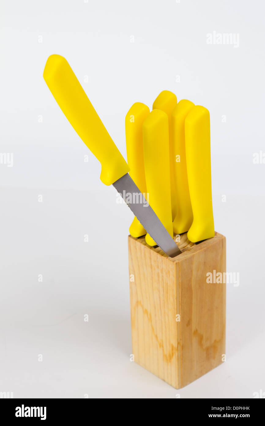 One group of yellow knives on an wooden support Stock Photo - Alamy